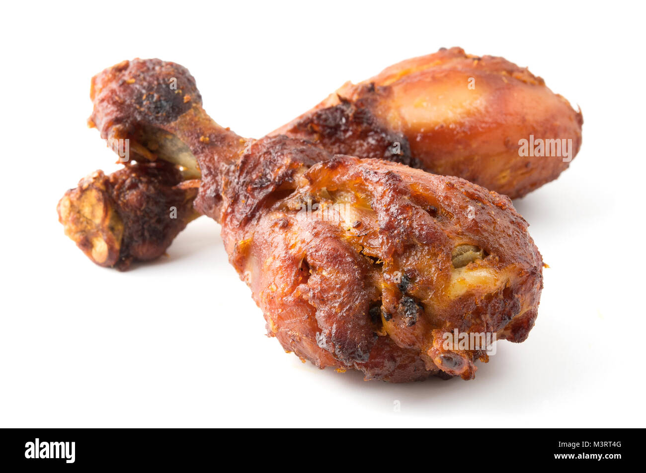 Roasted chicken legs on a white background Stock Photo - Alamy