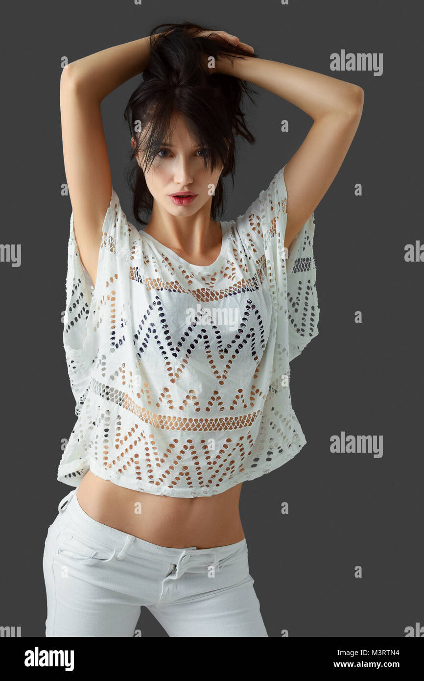 Attractive girl lifting her hair up with both hands. Messy hairstyle ...