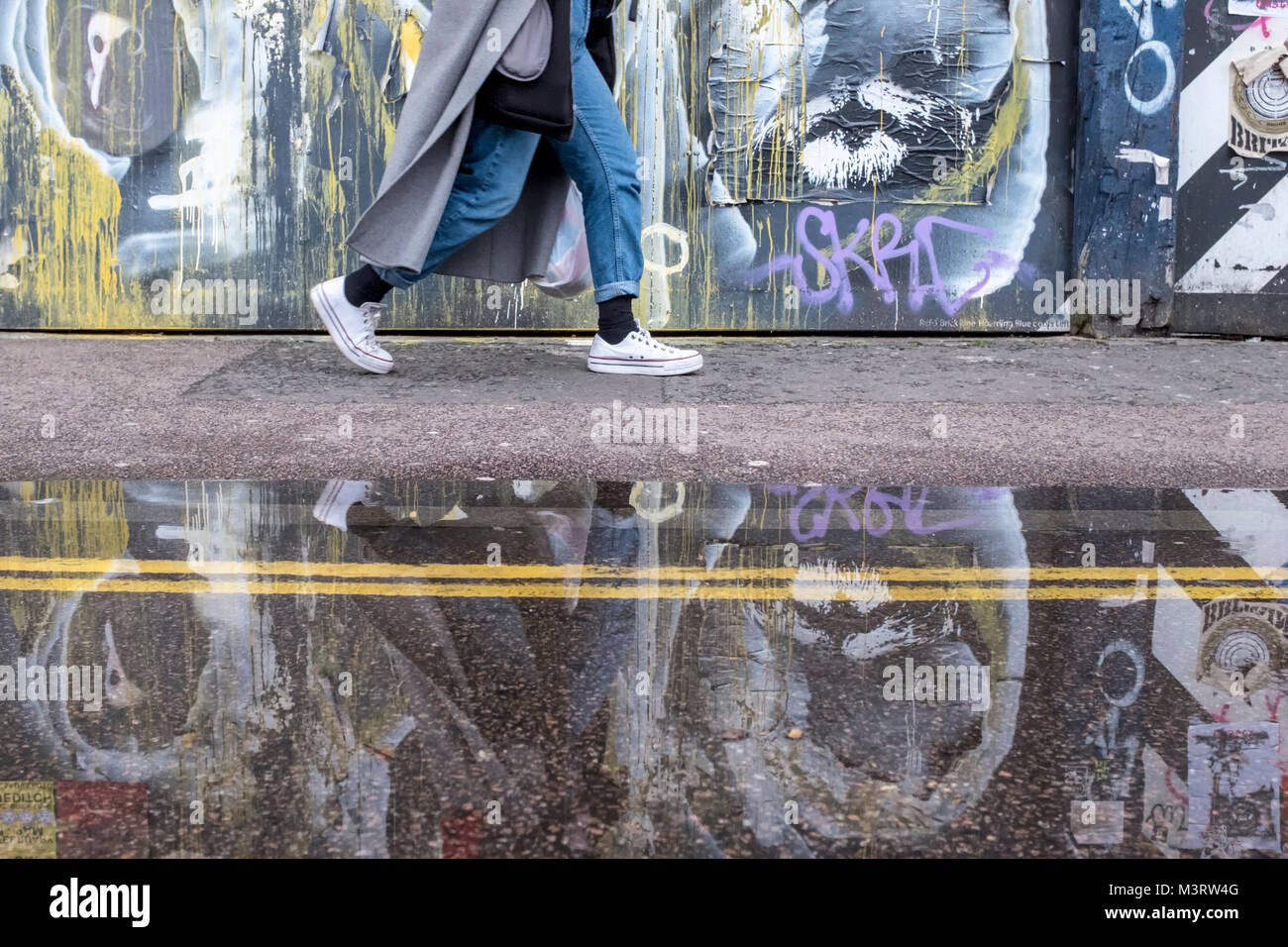 Walking by Graffiti Stock Photo - Alamy