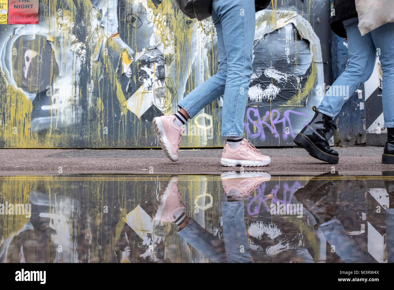 Walking by Graffiti Stock Photo - Alamy