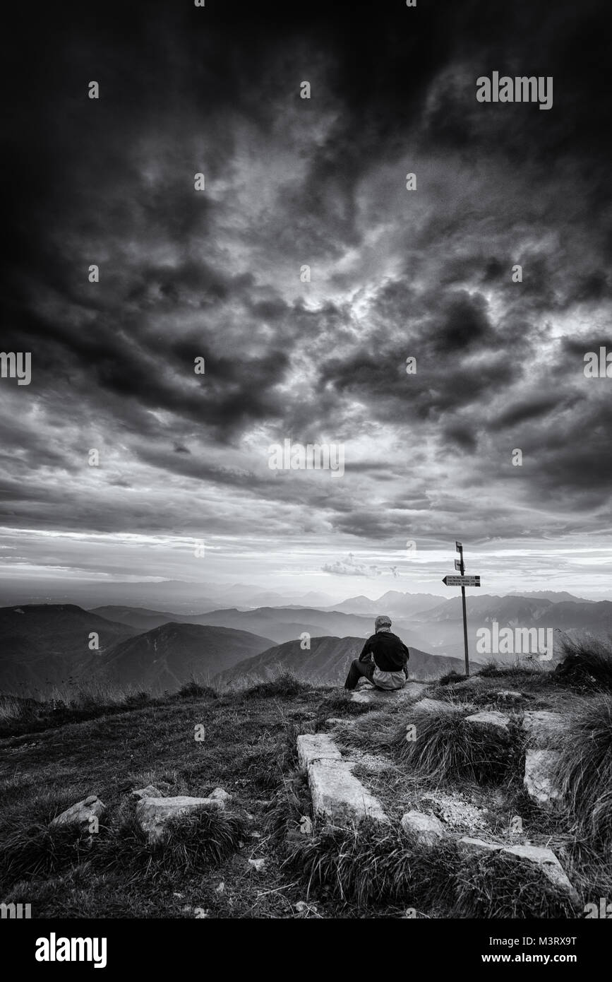 A lonely trekker wondering which path to take Stock Photo - Alamy