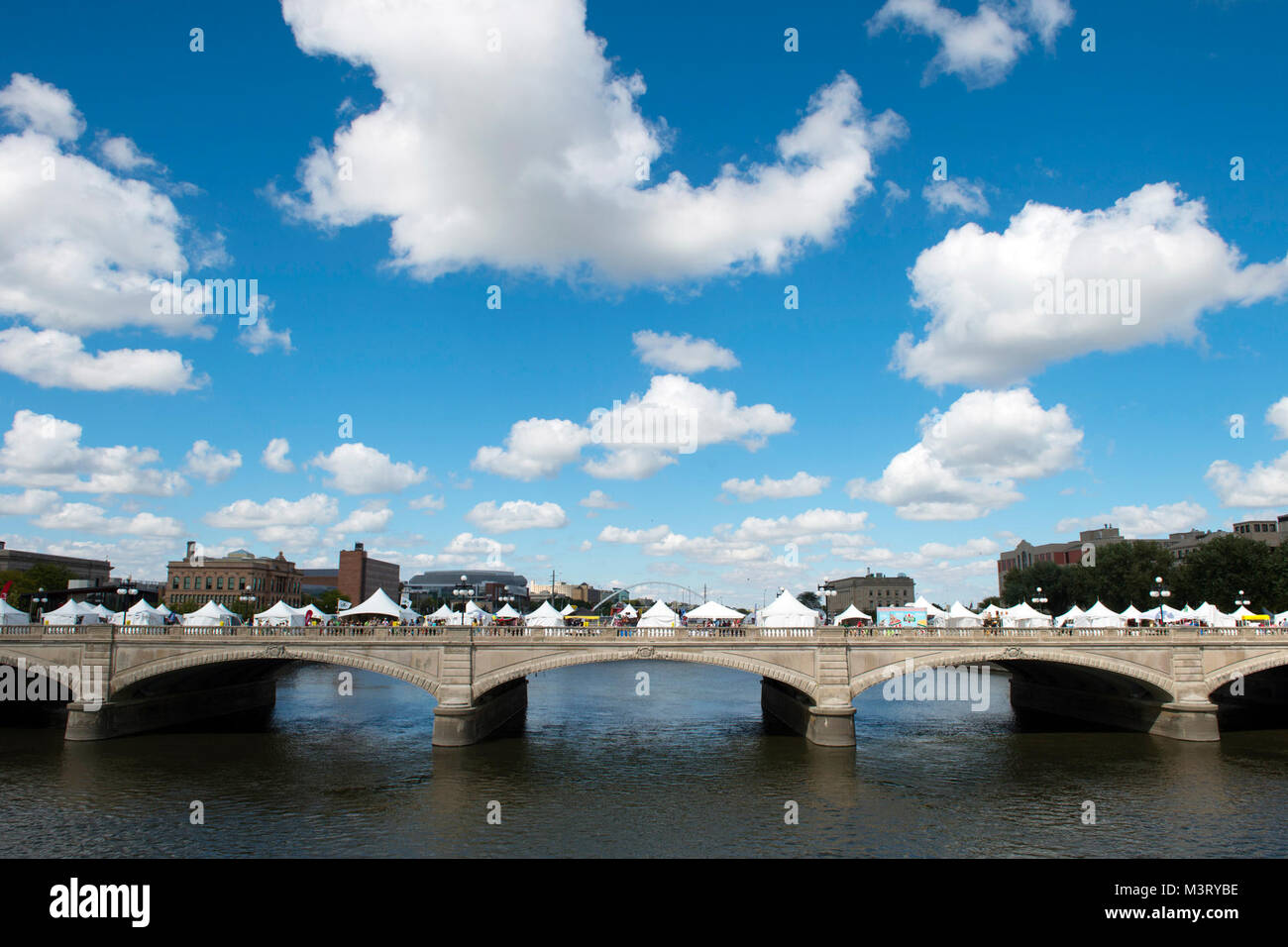 Exhibit and vendor booths line a bridge crossing the Des Moines River ...