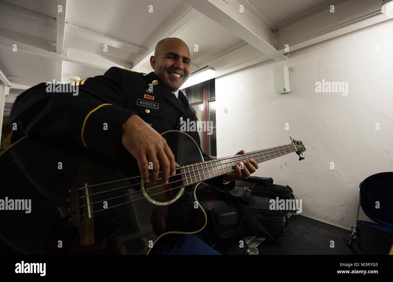 U.S. Army Sergeant Juan Acosta, a bassist with the United States Army ...