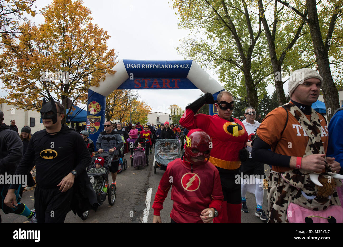 Participants in a Red Ribbon Run Superhero 5k event begin running at ...