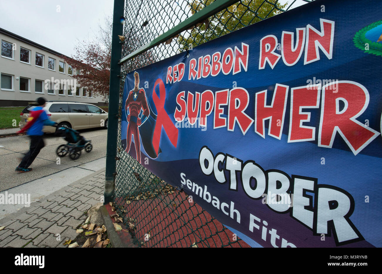 Participants in a Red Ribbon Run Superhero 5k event run towards the ...