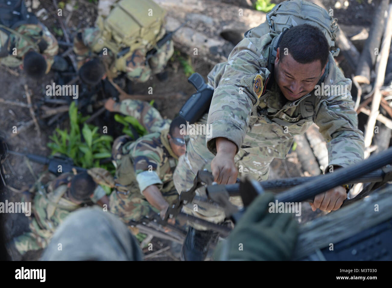 Belizean security forces members climb a ladder to board a U.S. Army CH ...