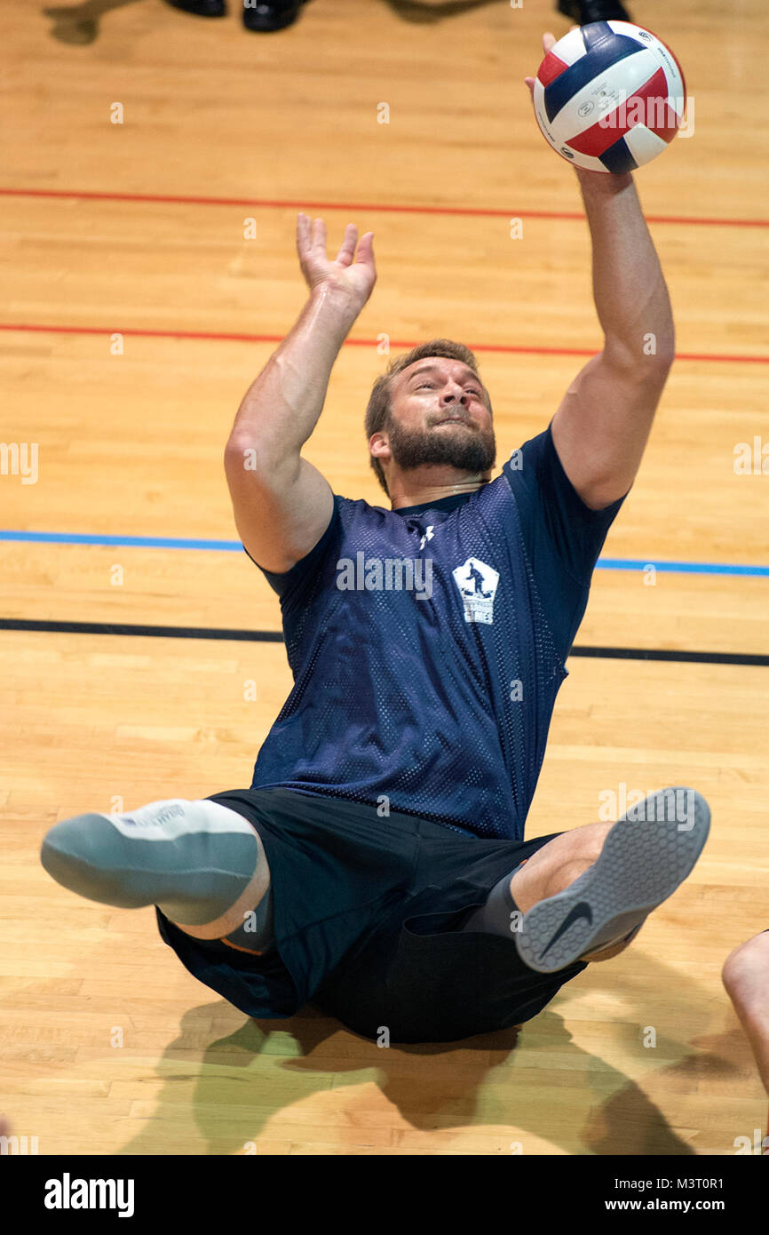 Navy veteran Max Rohn leans back to keep a volleyball in play during ...