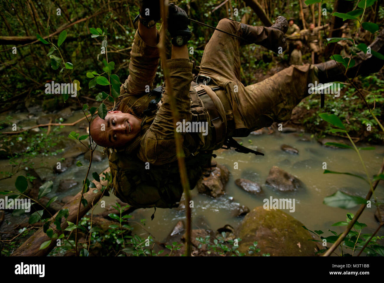 Special Tactics Officer Capt. Jack Ambridge uses a rope bridge to cross ...