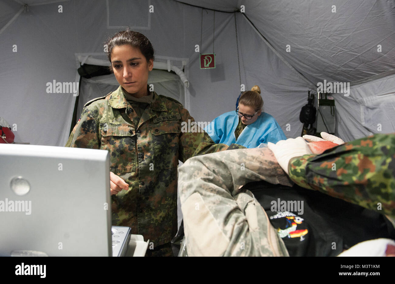 Dr. Willms, a member of the German Army (Bundeswehr), uses an ...