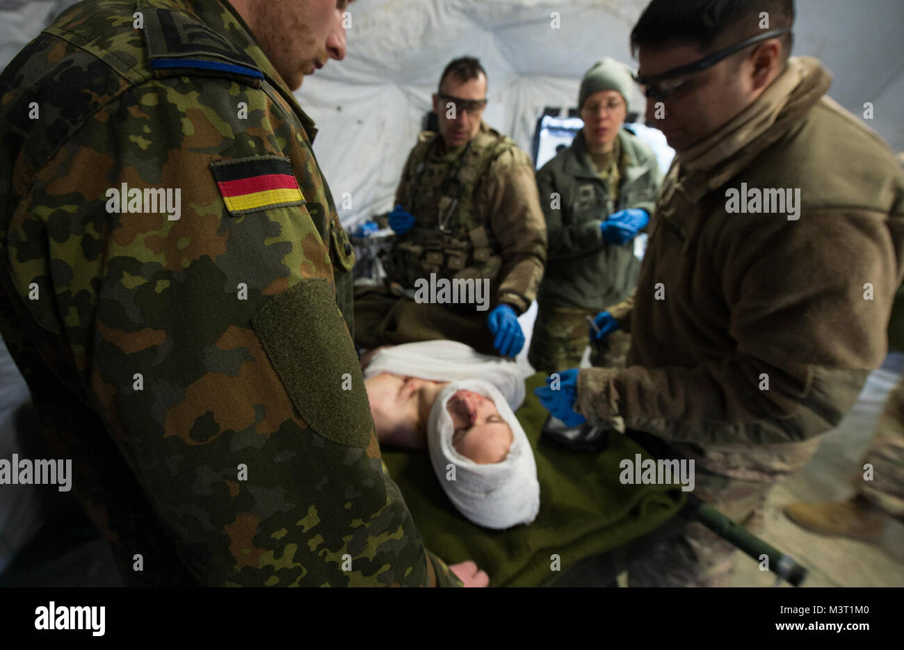 U.S. and German medical teams work together to treat a simulated ...