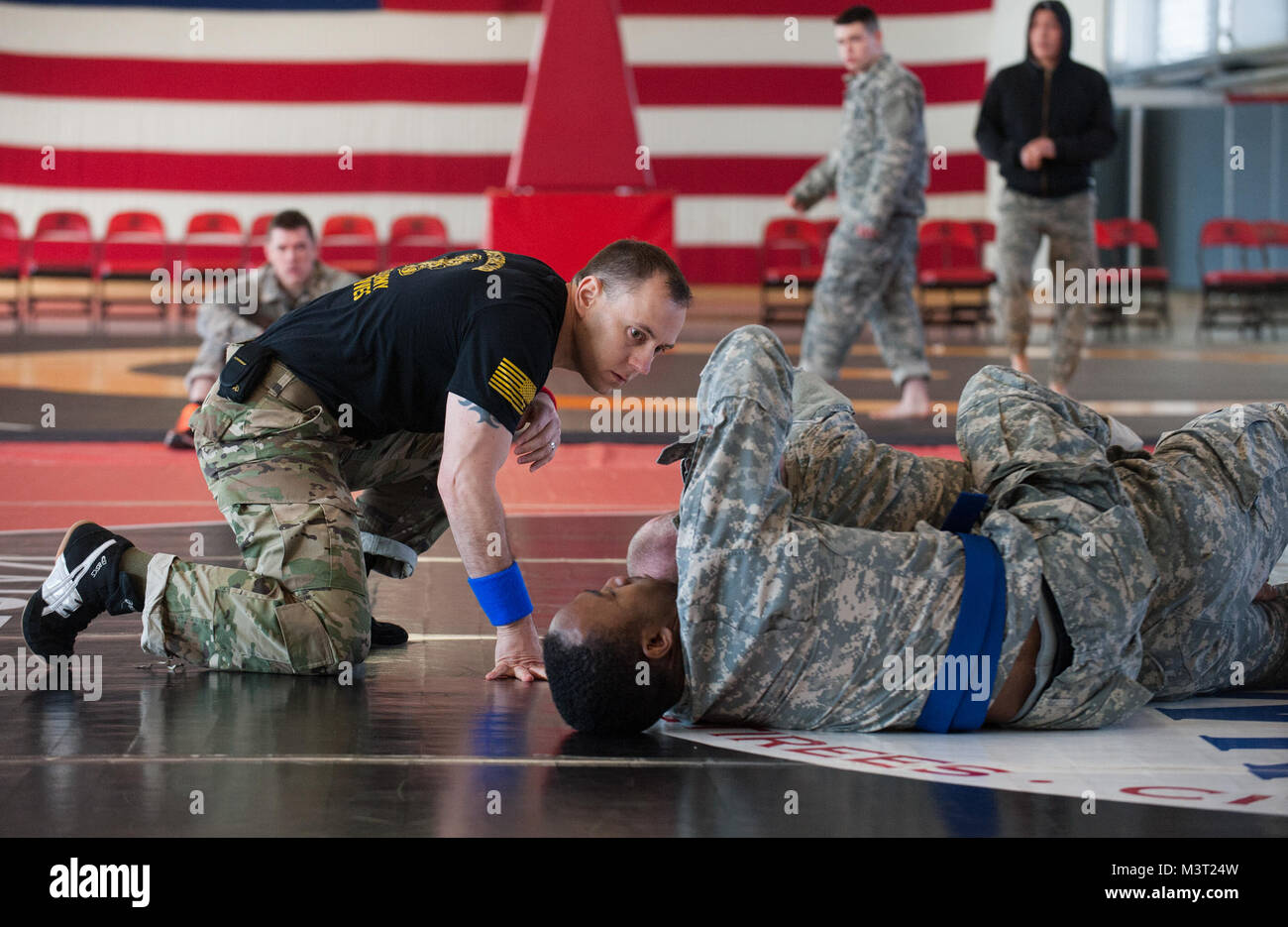 Army Master Sgt. Richard Silva, an army combatives instructor, refs a ...