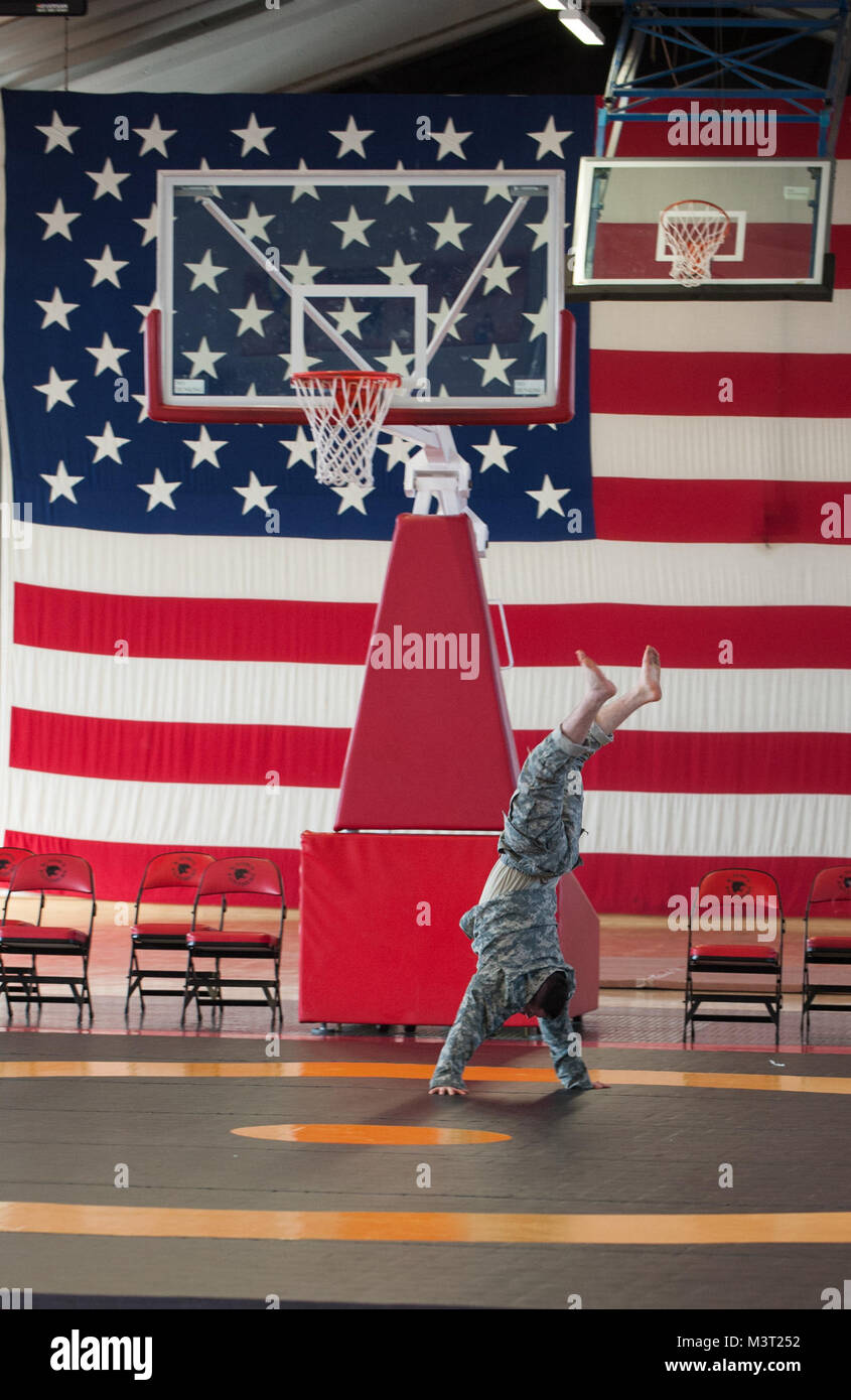 U.S. Army Private 1st Class Bobby Medina warms up with a hand-stand ...