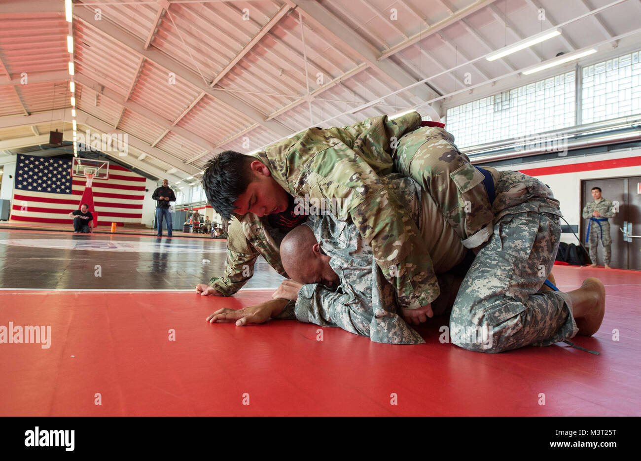 U.S. Army Private 1st Class Victor Rodriguez (top) takes the rear mount ...