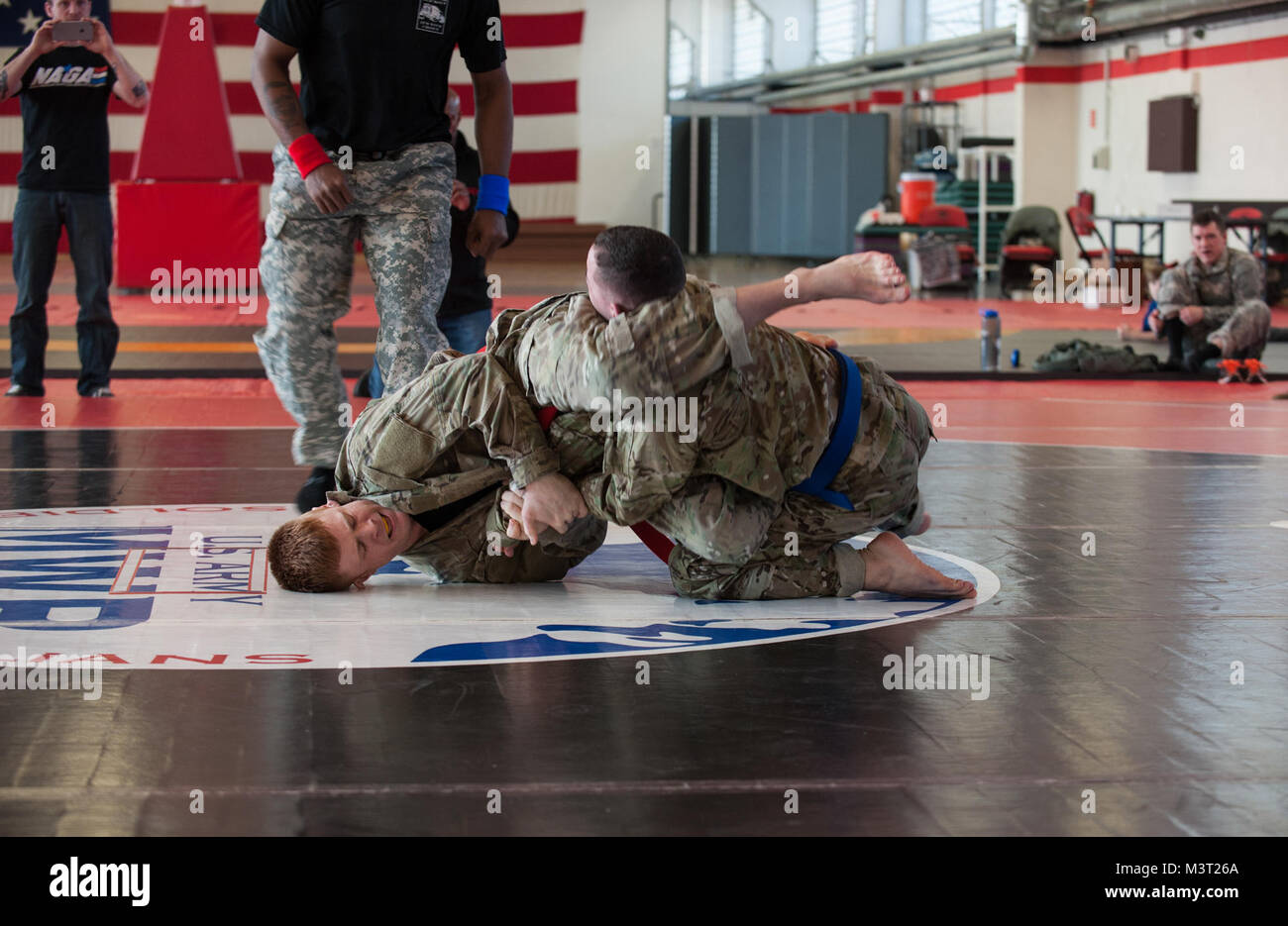 U.S. Air Force Staff Sergeant Joseph Everett (left) grapples against U ...