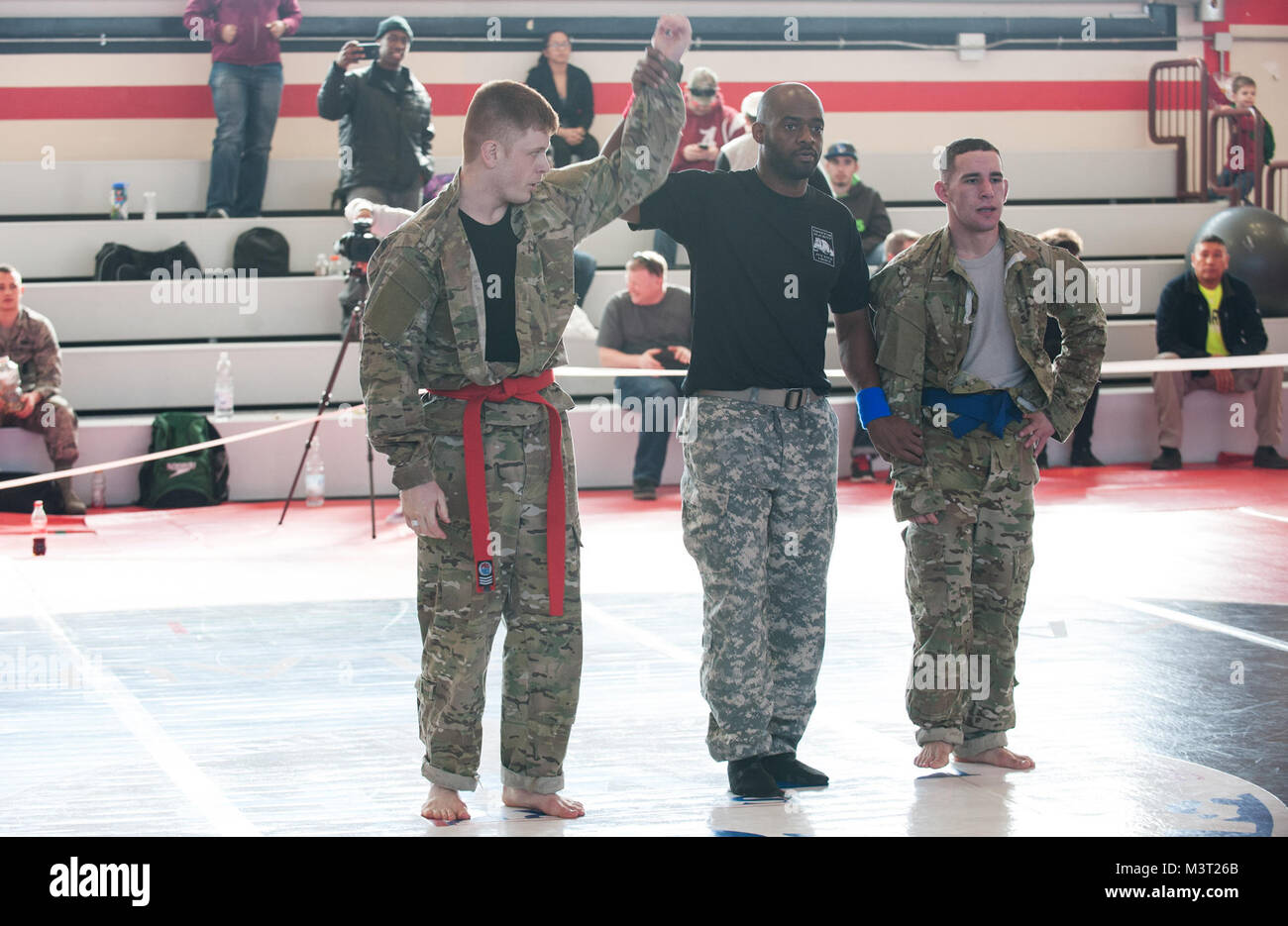 U.S. Air Force Staff Sergeant Joseph Everett (left) raises his hand ...