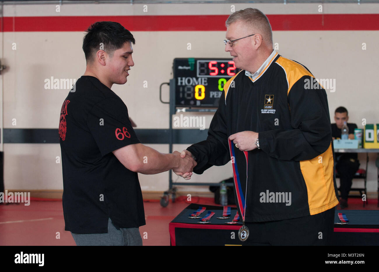 U.S. Army Private 1st Class Victor Rodriguez (left) receives a 2nd ...