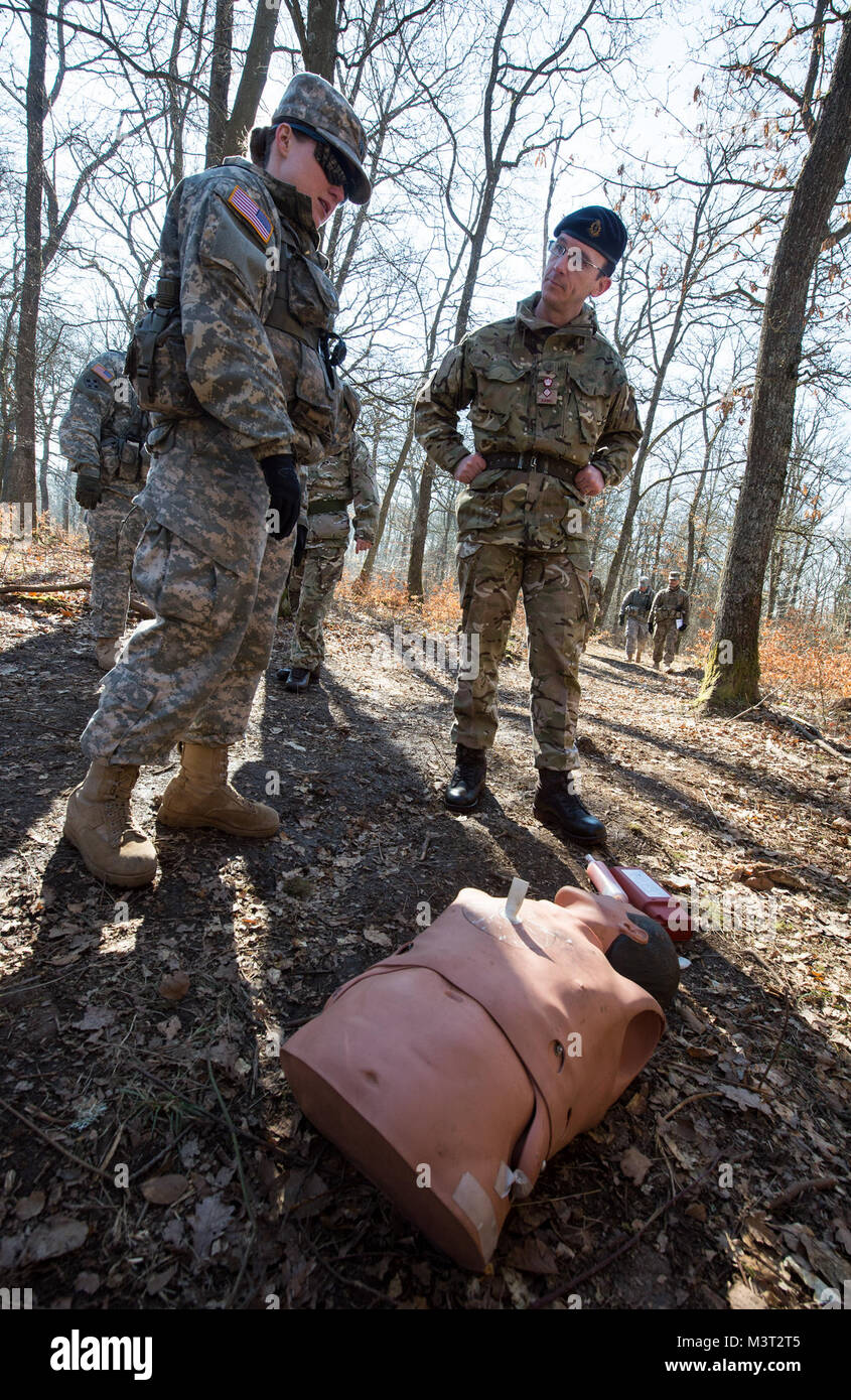 U.S. Army Sergeant Rachel Hall (left), an EFMB evaluator, briefs ...