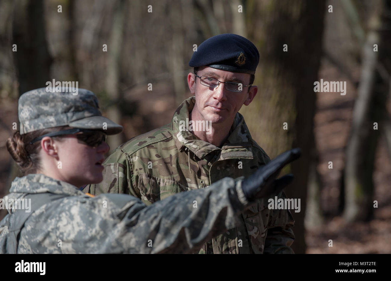 U.S. Army Sergeant Rachel Hall (left), an EFMB evaluator, briefs ...