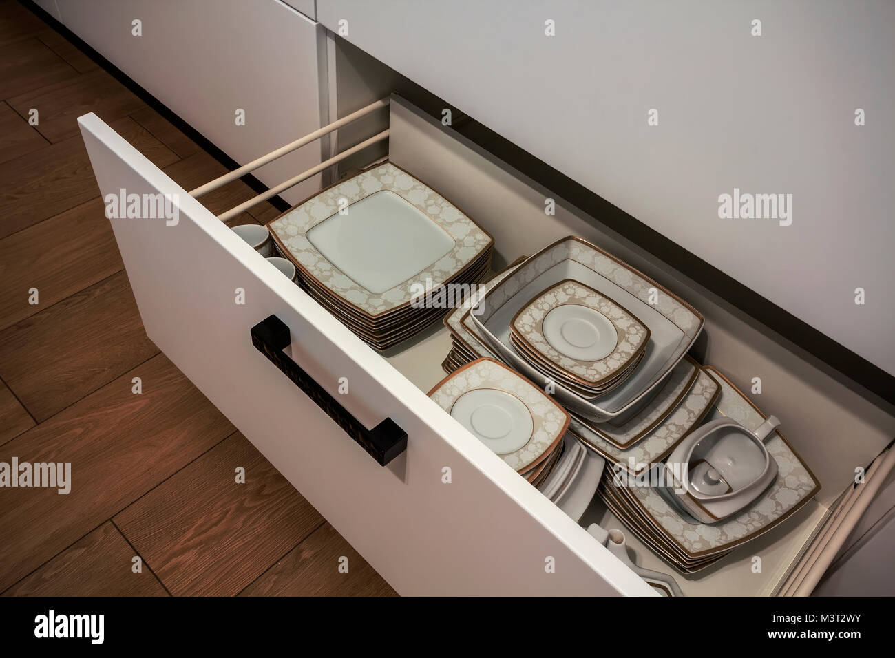 Open kitchen drawer with plates inside, a smart solution for kitchen ...