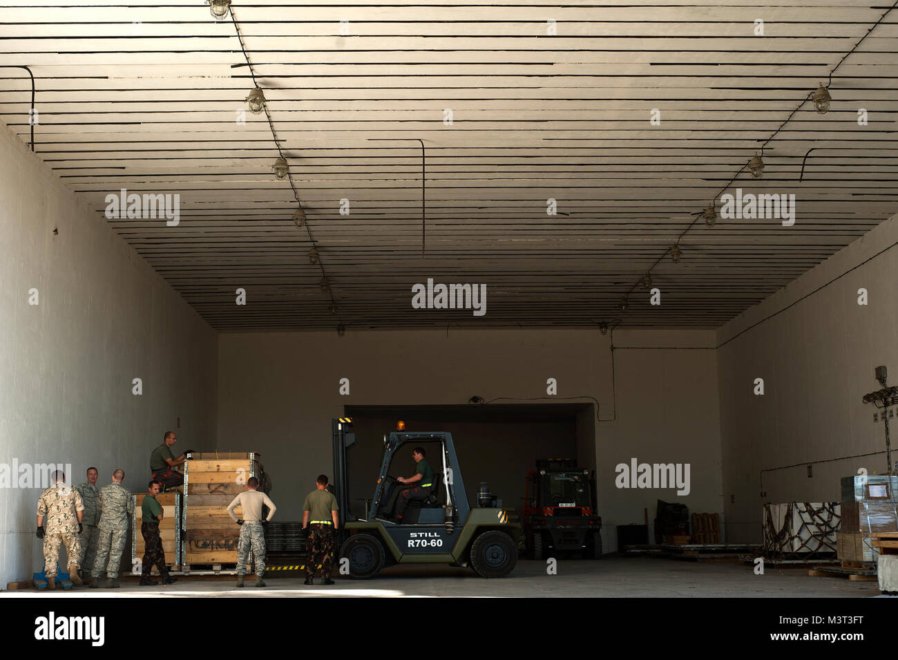 Aerial porters assigned to the Heavy Airlift Wing work alongside their ...