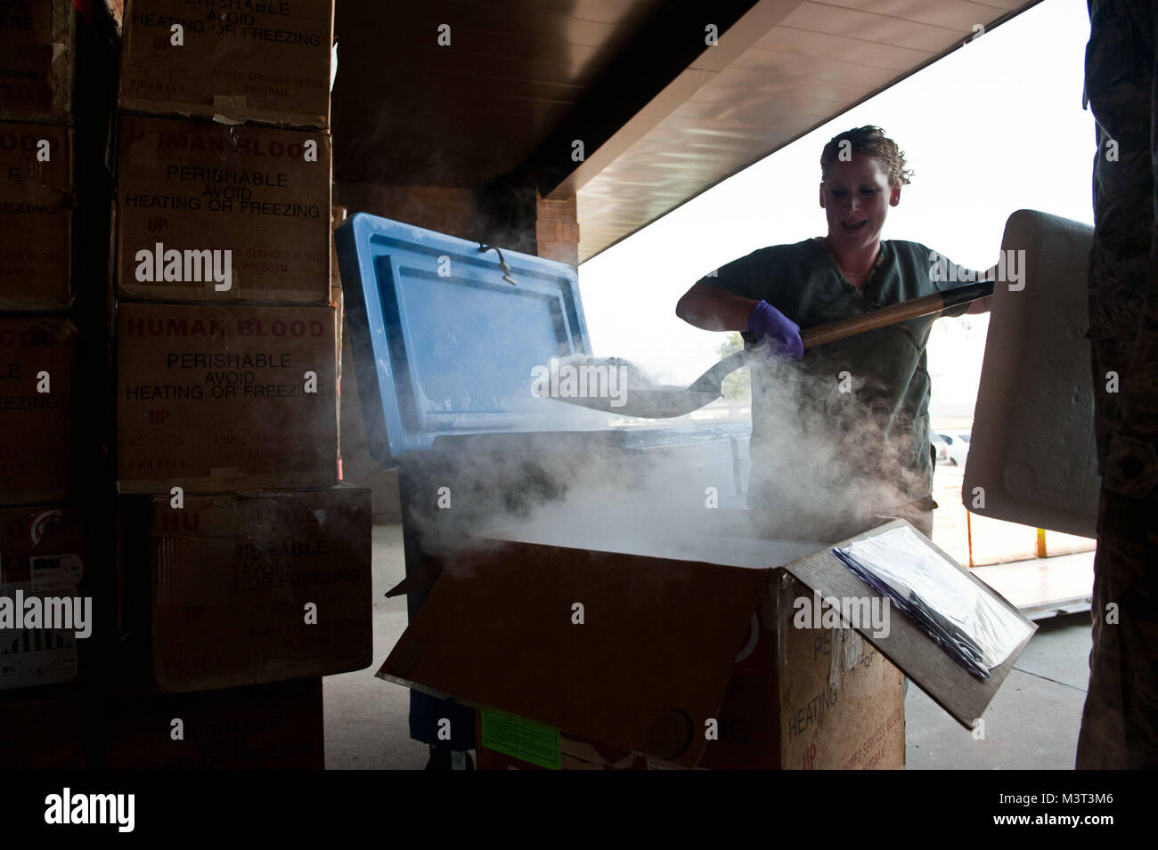 Sarah Vasil, a laboratory technician, loads dry ice on top of blood ...
