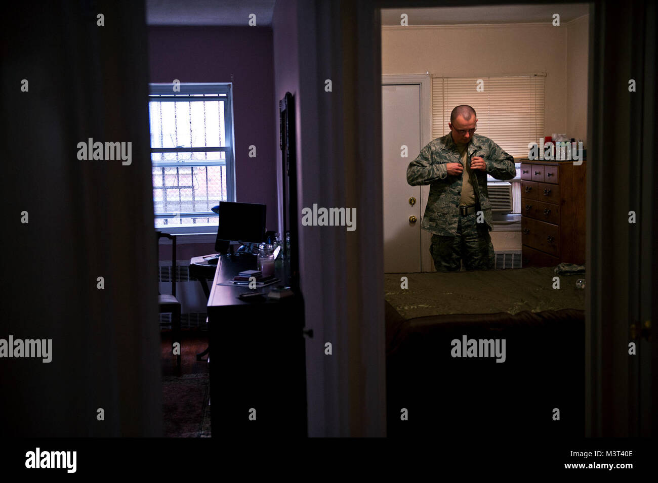 Airman 1st Class Wojciech "Peter" Grajewski prepares for work at his ...