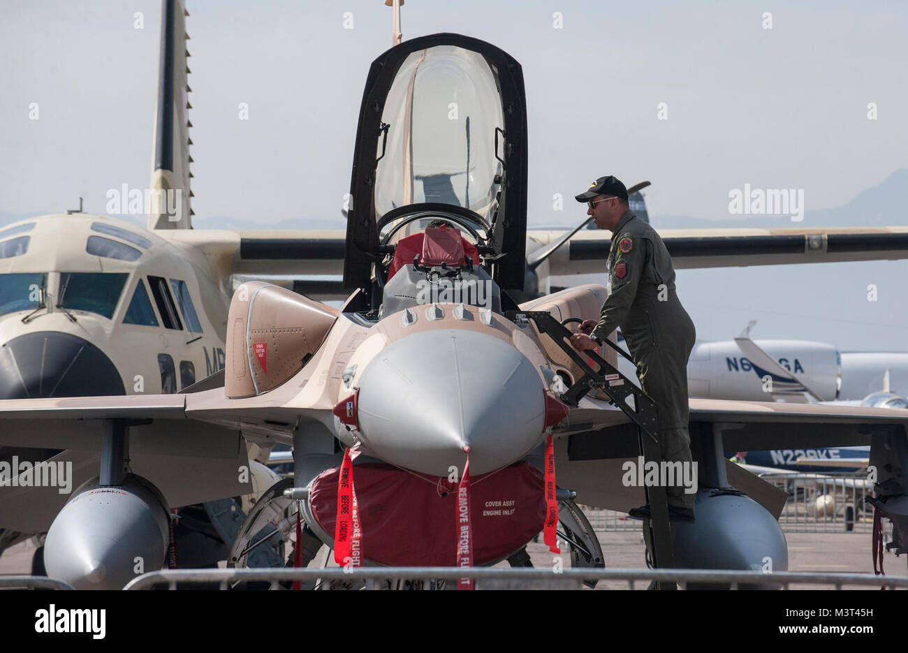 A Moroccan F-16 pilot shows the inside of the aircraft to a spectator ...