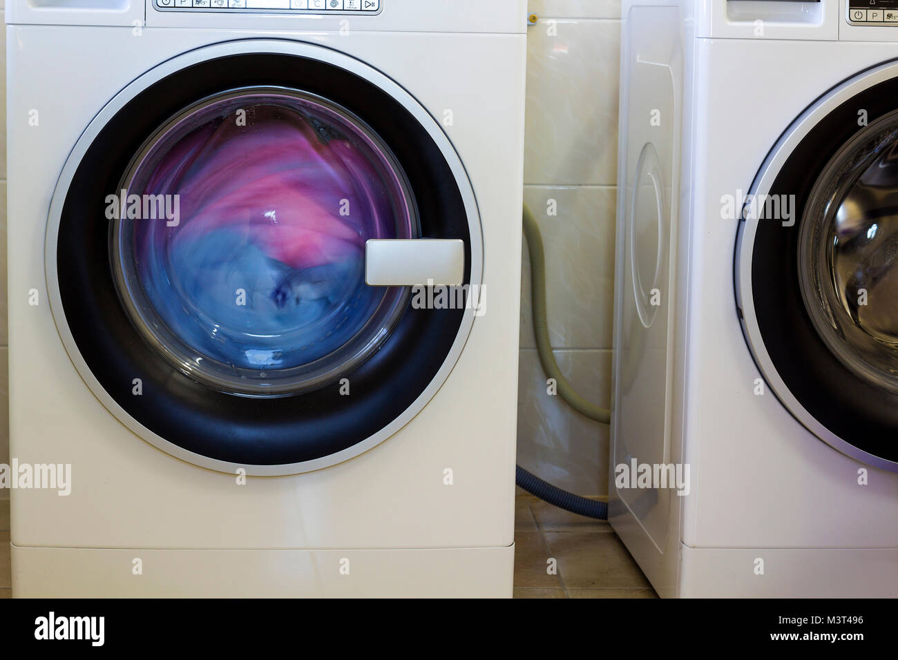 Colorful clothes and towels in washing machine Stock Photo - Alamy
