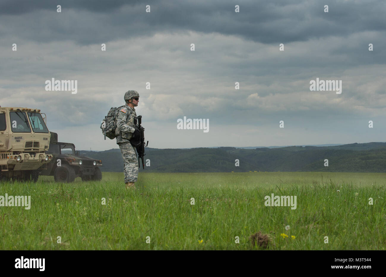 A U.S. Army Soldier maneuvers through a field during the 10th Army Air ...