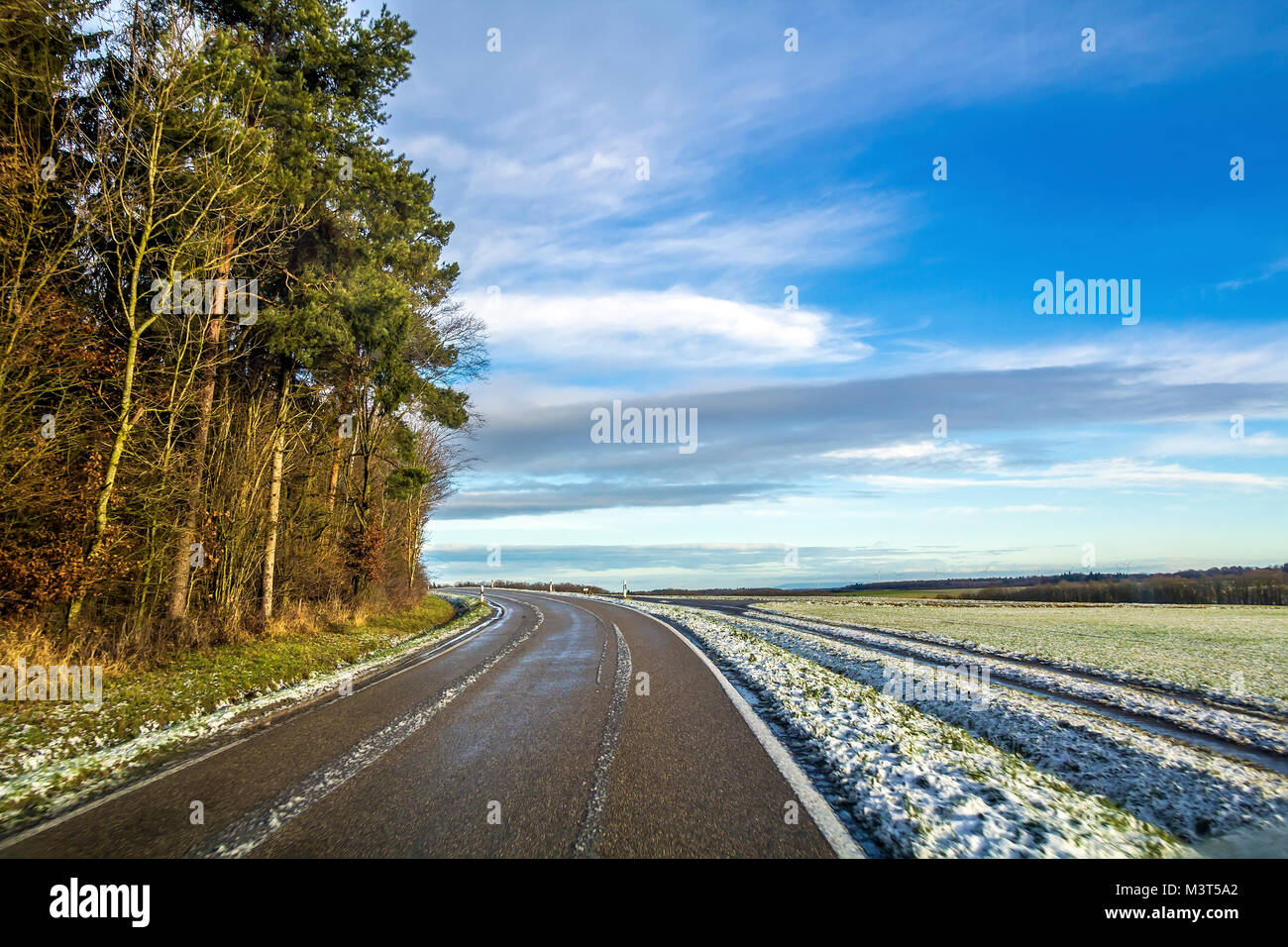 Empty black asphalt road between green fields Stock Photo - Alamy