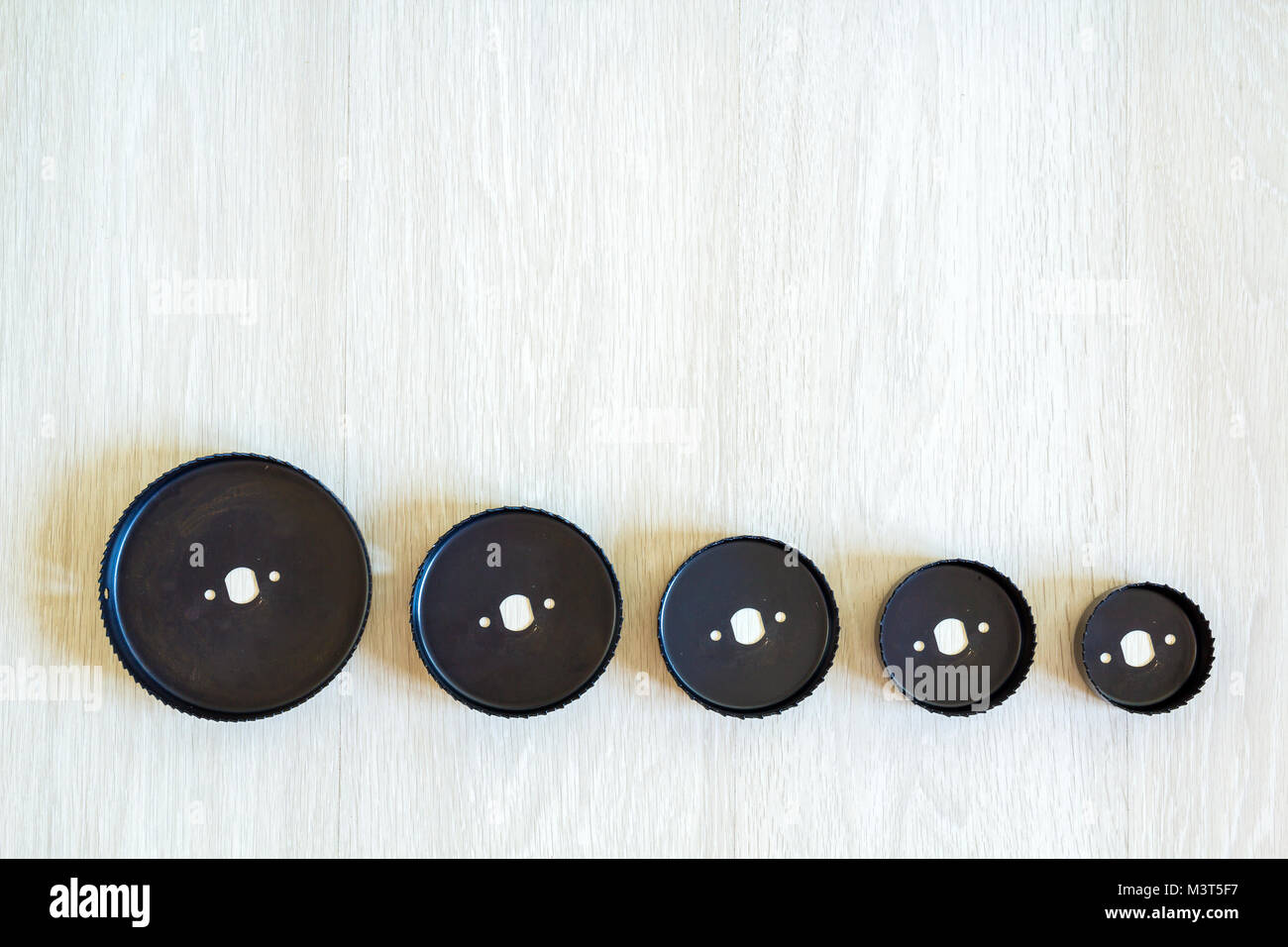 Set of metal discs for cutting holes. Top view Stock Photo - Alamy