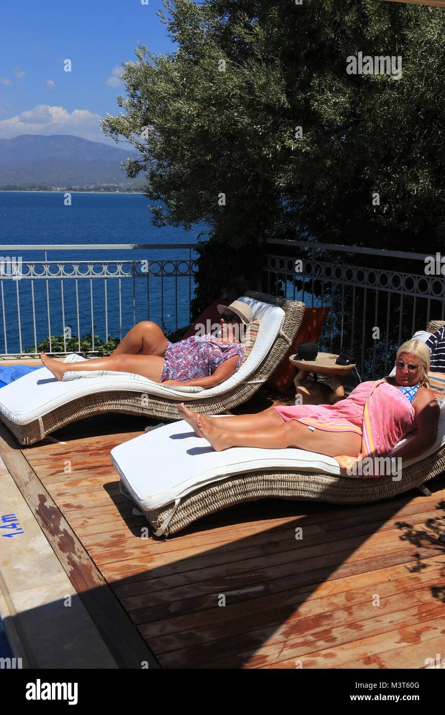 28TH JULY 2017, SOVALYE ISLAND,TURKEY:Two english ladies relaxing on ...