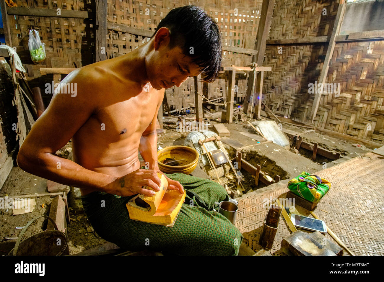 Close up of a worker checking very thin layers of beaten gold Stock ...