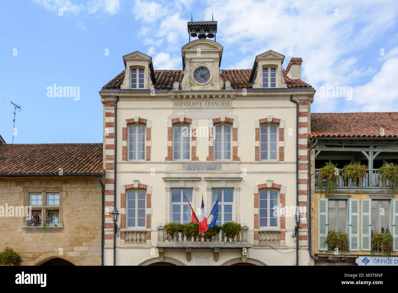Town hall (Mairie / Hotel de Ville) with French flags and bells in ...
