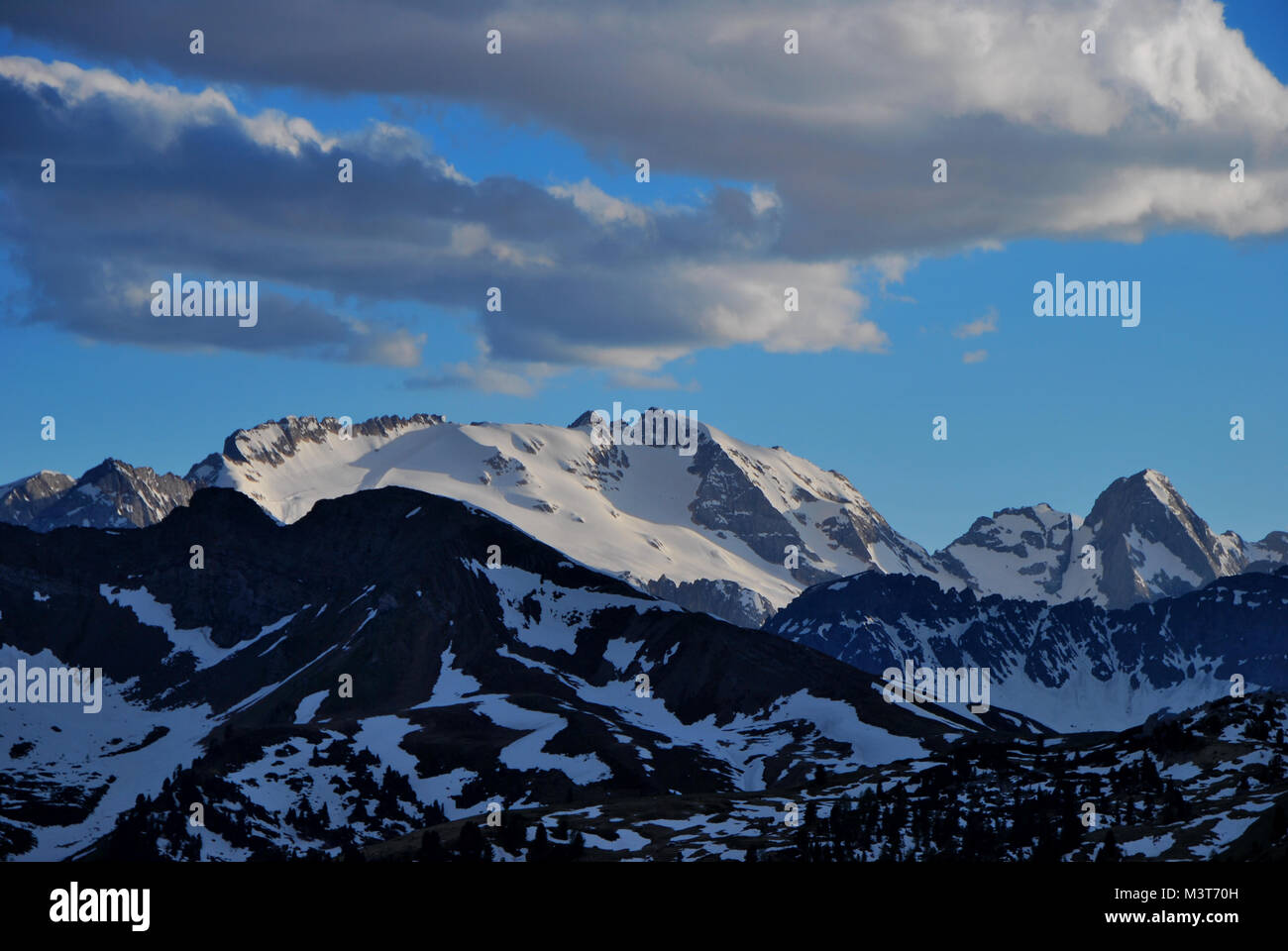 beautiful high mountains with lots of snow and blue sky Stock Photo - Alamy