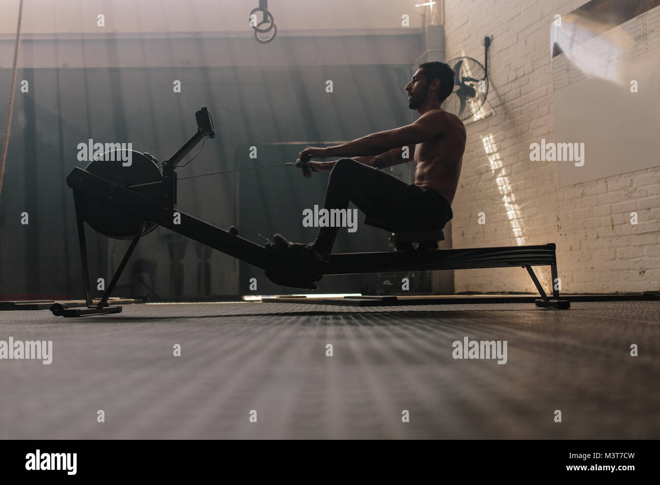 Male using rowing machine hi-res stock photography and images - Alamy