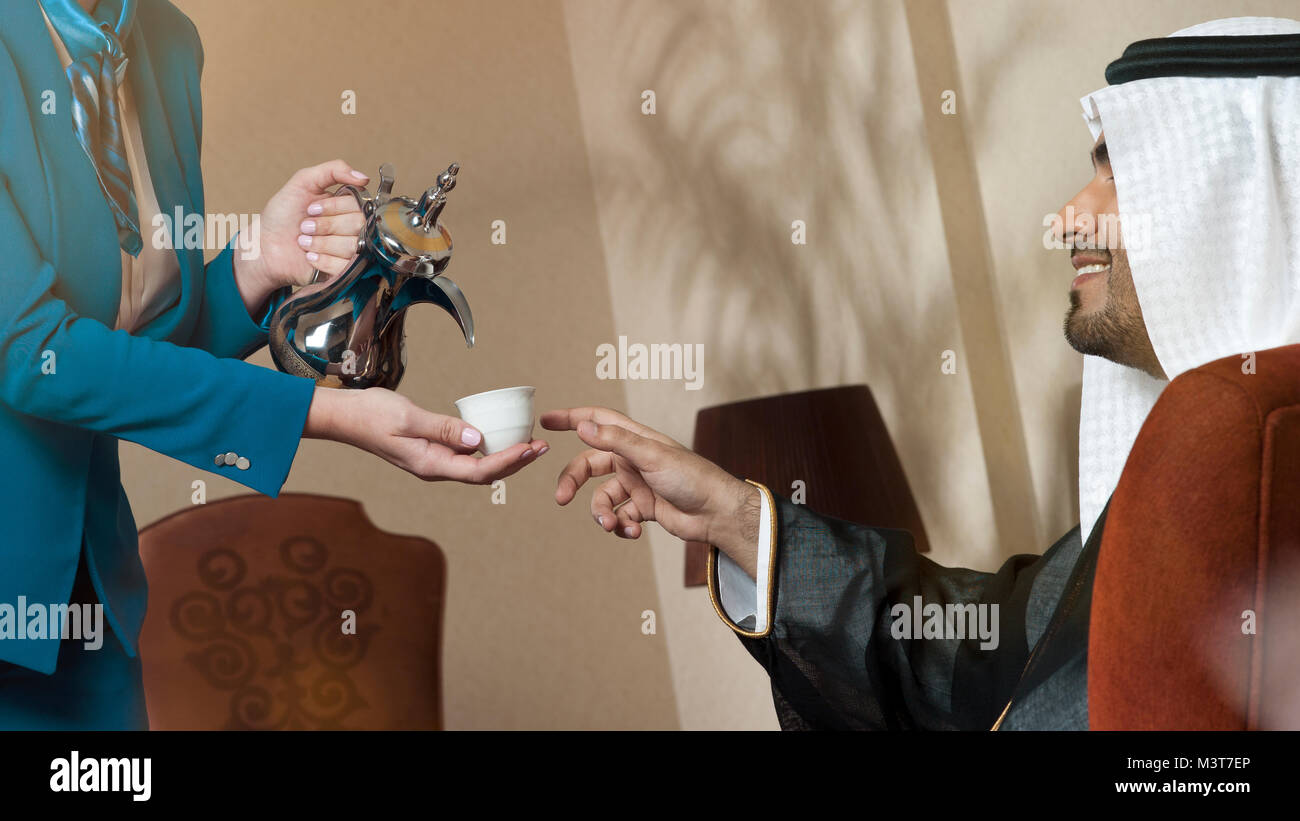 Waitress Serving Arabic Coffee to a Wealthy Saudi Arab Man Stock Photo ...