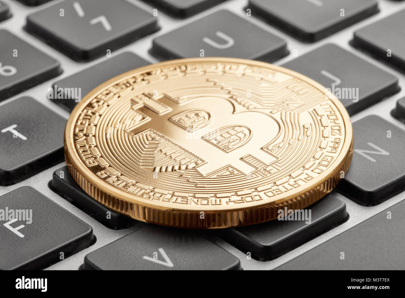Golden bitcoin on computer keyboard with black keys Stock Photo - Alamy