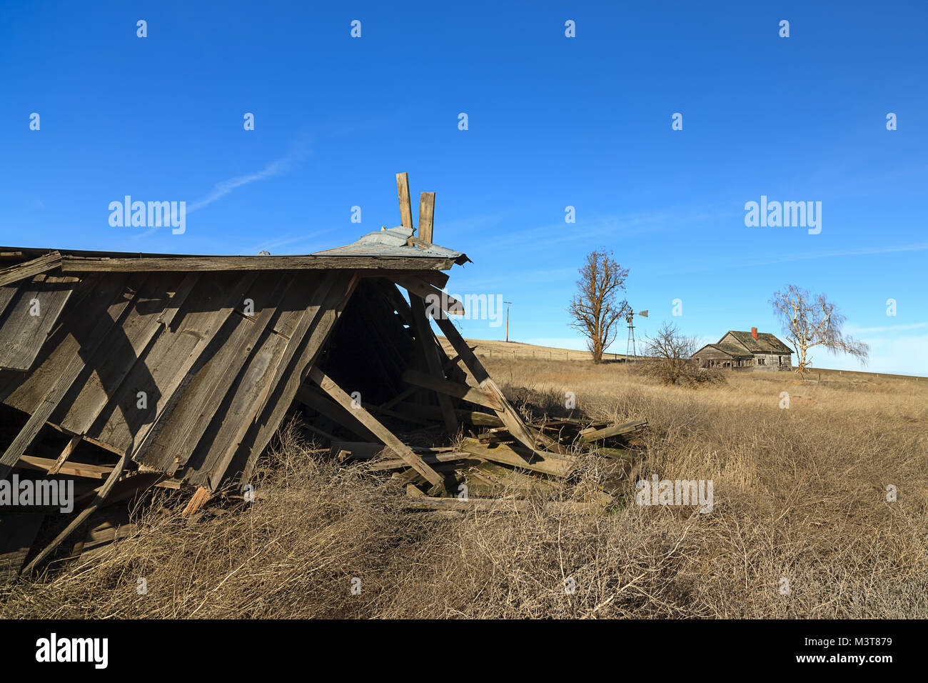 A fallen old barn with an abandoned house in eastern Washington Stock ...