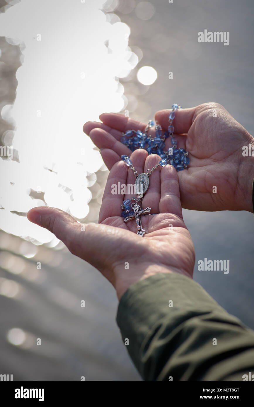 Womans hands holding rosary hi-res stock photography and images - Alamy