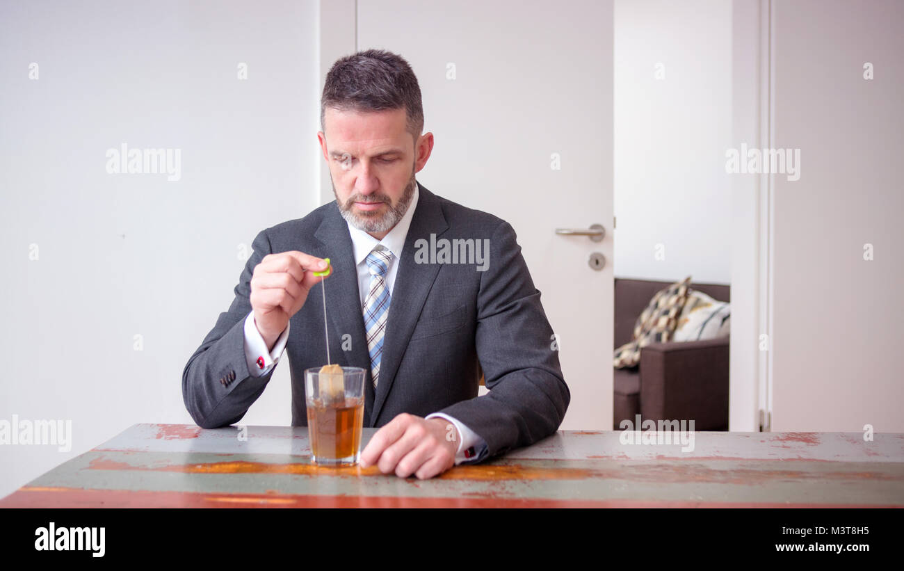 Man in suit sitting hi-res stock photography and images - Alamy