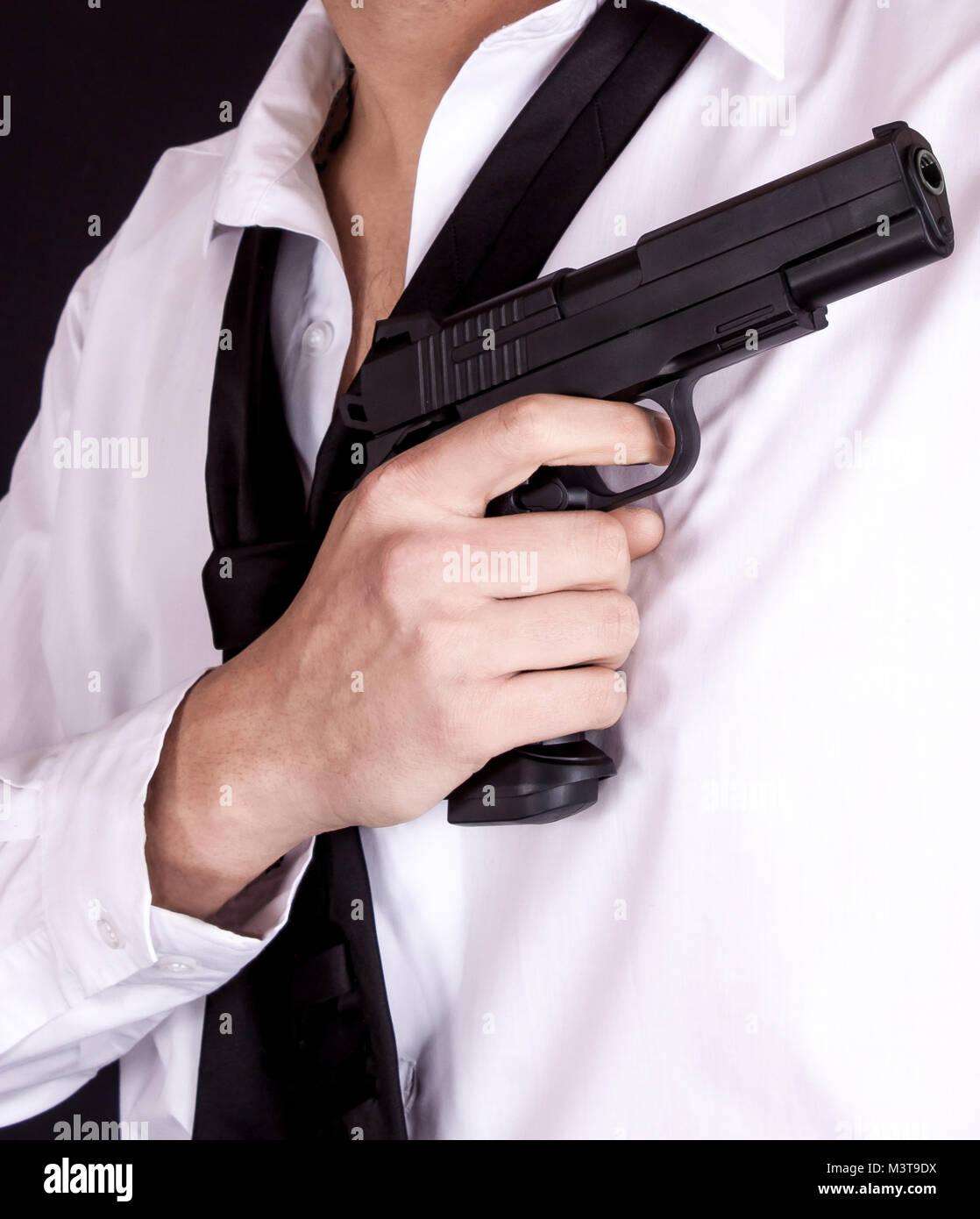 Man in black suit holding gun in hand. Secret agent, mafia, bodyguard ...