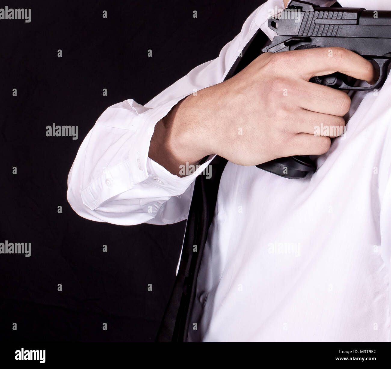 Man in black suit holding gun in hand. Secret agent, mafia, bodyguard ...