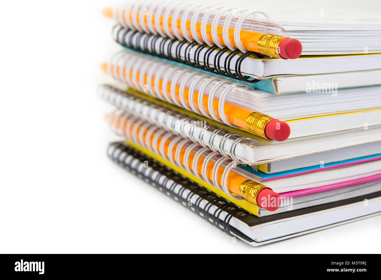 Stack of colorful notebooks with pencils isolated on white Stock Photo ...