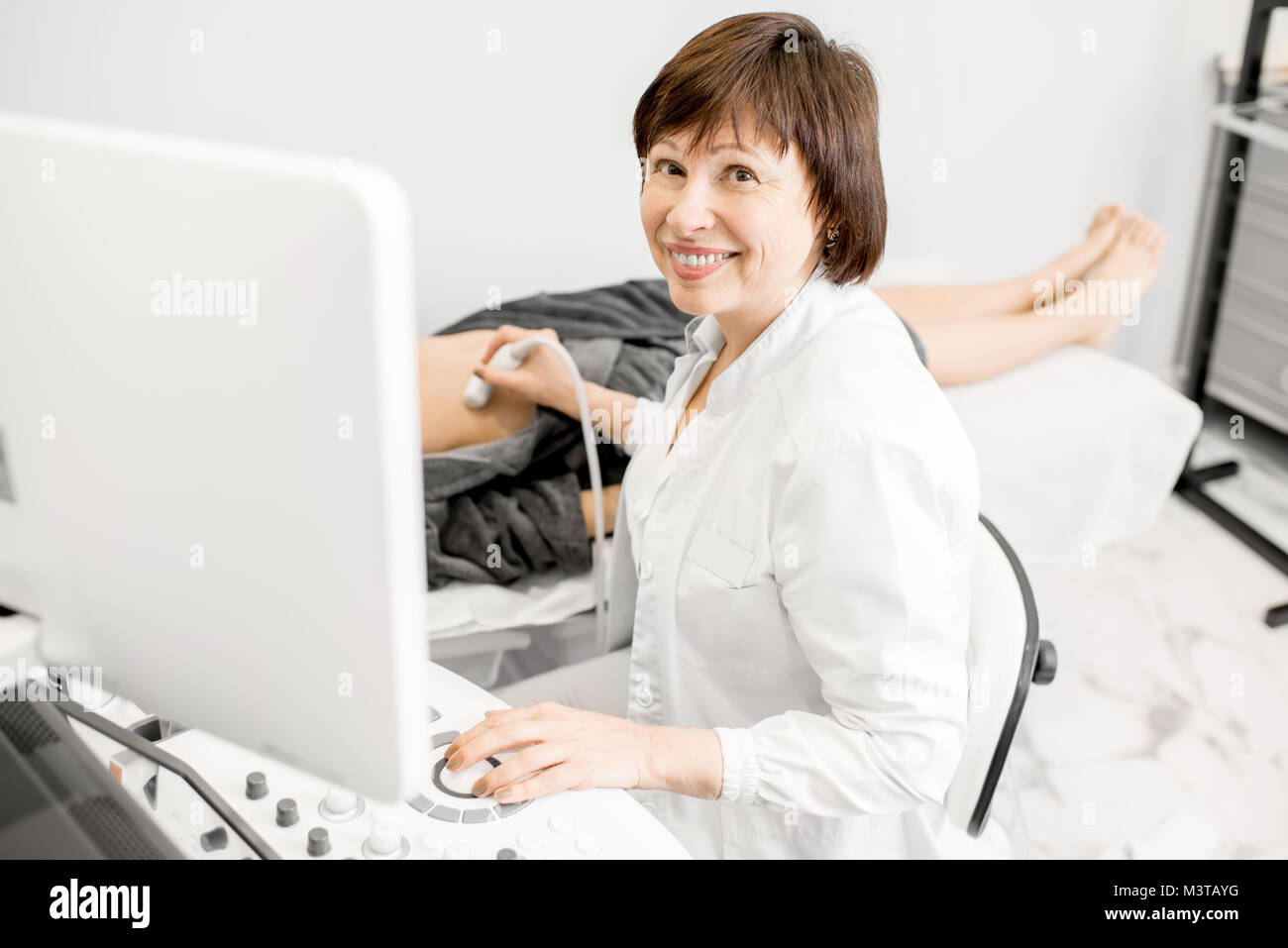 Doctor making ultrasound examination to a young woman Stock Photo - Alamy