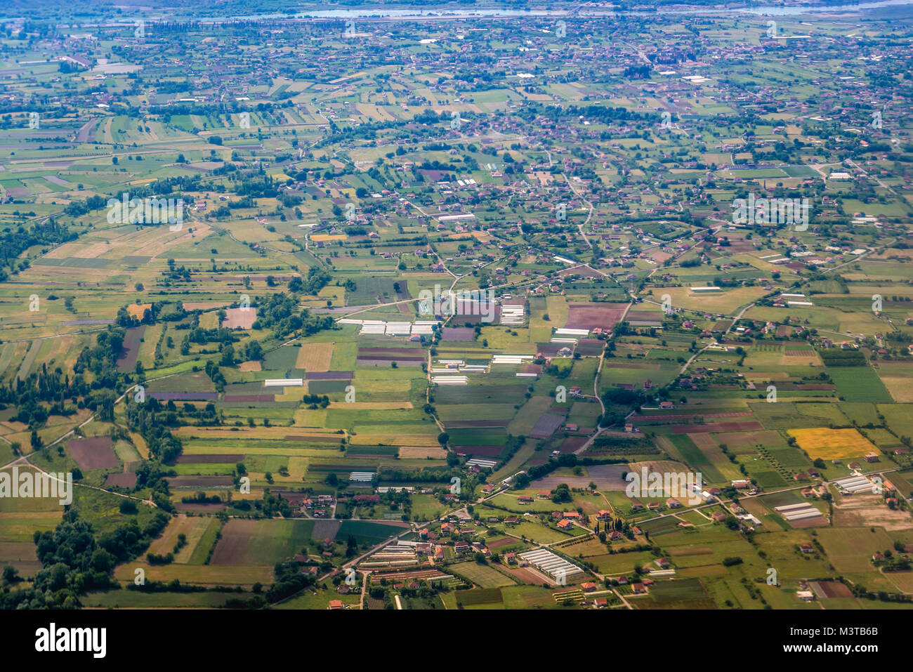 Aerial view from plane window on rural area around Podgorica Airport in ...