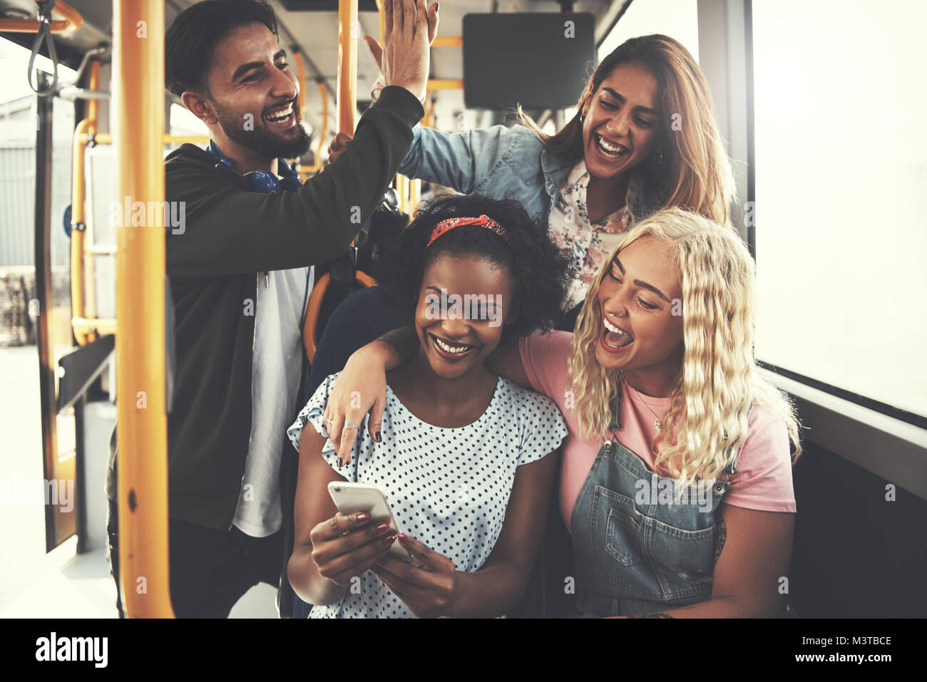 Laughing texting friends smartphone hi-res stock photography and images ...