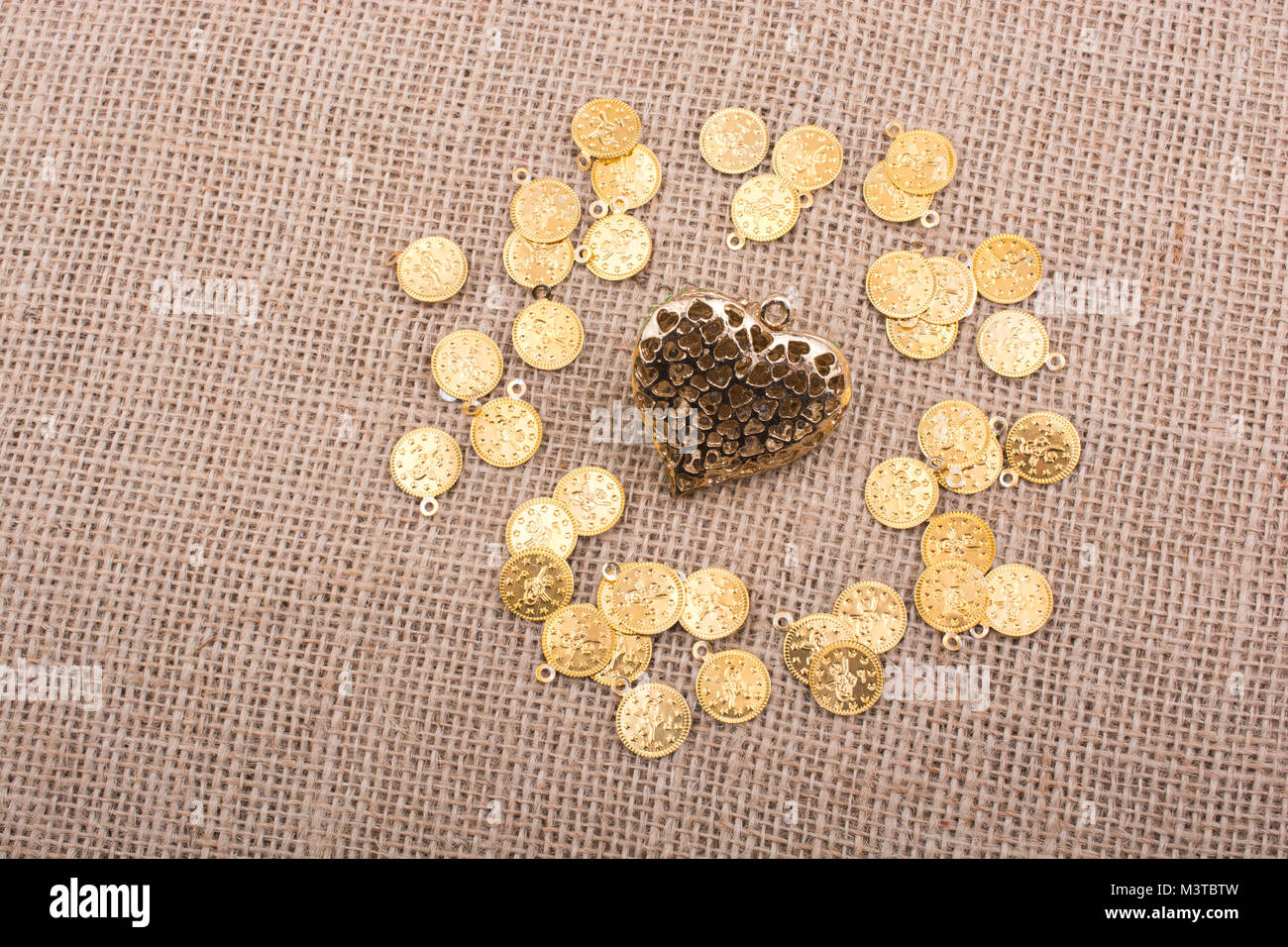Hand holding heart coins hi-res stock photography and images - Alamy