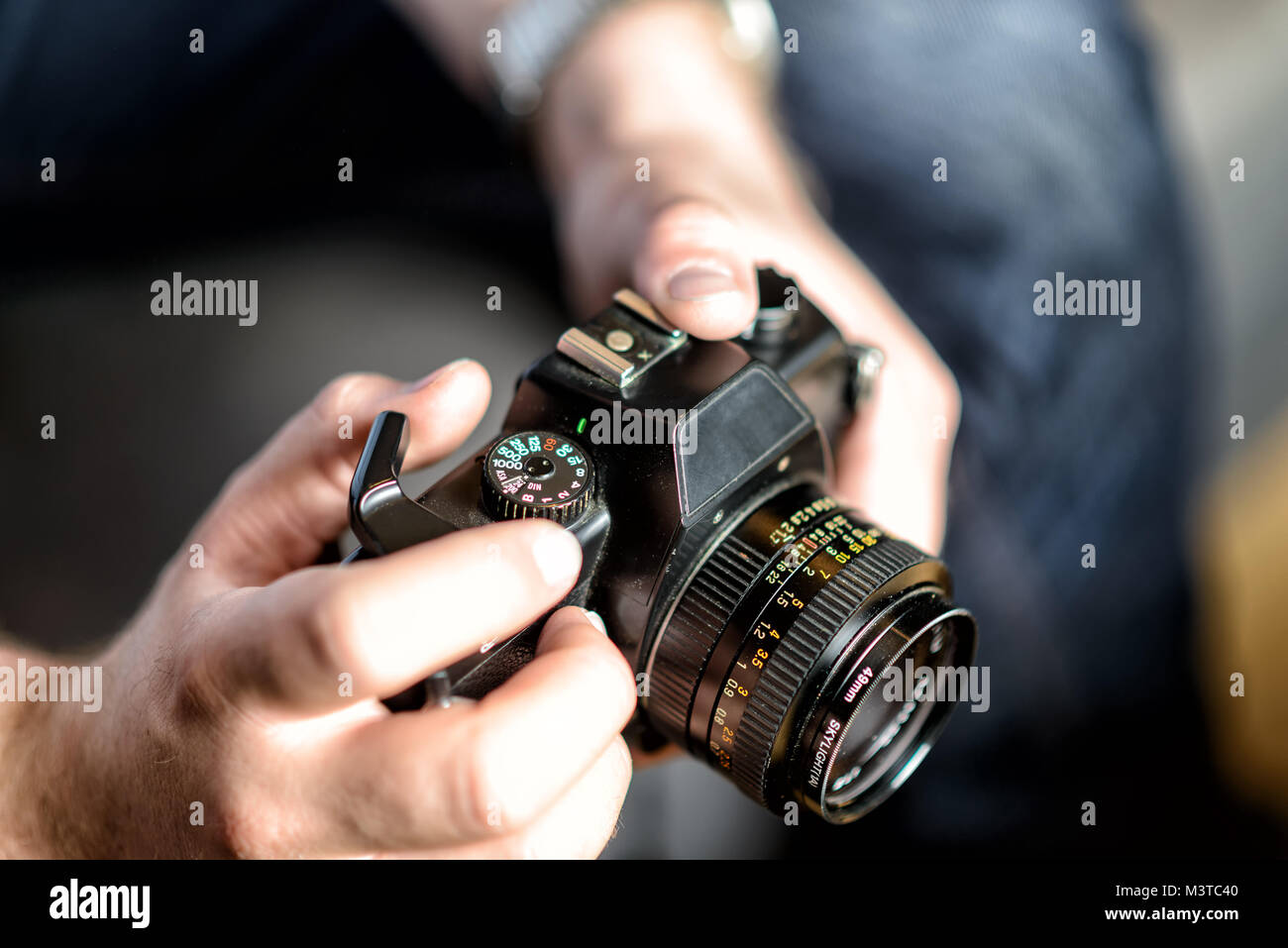 man holding a vintage camera with standard lens in his hands Stock ...