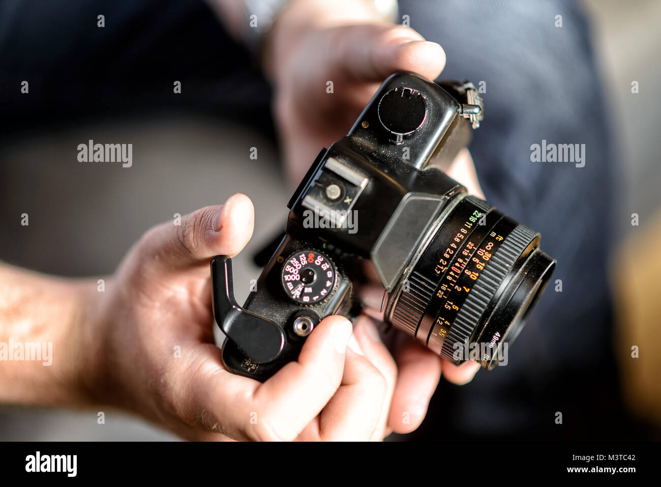 man holding a vintage camera with standard lens in his hands Stock ...